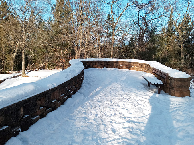 Winter transforms the overlook into a snow-covered wonderland, where the usual postcard view gets a frosty makeover worth the cold nose.