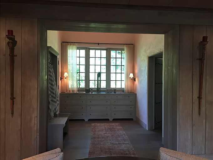 Soft light filters through windows in this transitional space, where thoughtful design creates moments of calm between rooms.