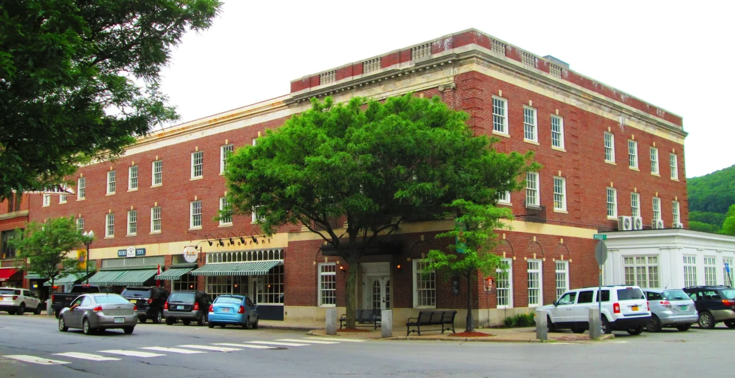 The stately Hotel Windham anchors downtown Bellows Falls, its brick facade and graceful proportions speaking to an era when travel meant elegance and adventure.