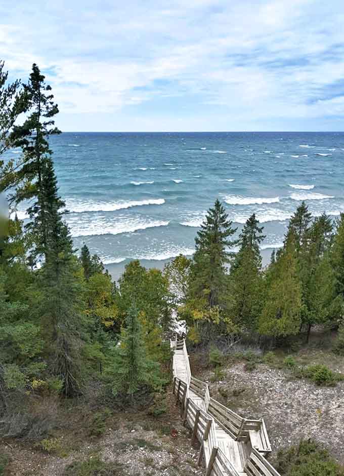 A wooden stairway beckons adventurers down to a hidden beach, where Lake Michigan's waves provide the soundtrack to paradise.