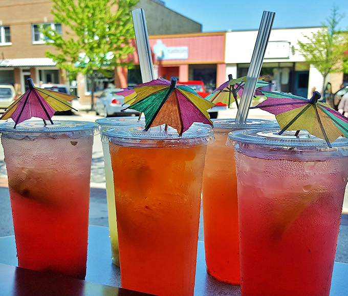 House-made lemonades with colorful umbrella garnishes offer the perfect tart counterpoint to the savory sandwich menu.