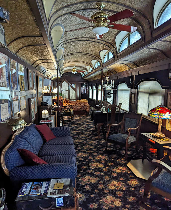 Relax in this spacious parlor car, where plush blue seating and elegant floral carpets create a perfectly refined vintage atmosphere.