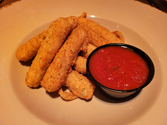 Golden-brown mozzarella sticks arrive hot and stretchy &ndash; comfort food that tastes even better when eaten under the watchful eye of a Stegosaurus.