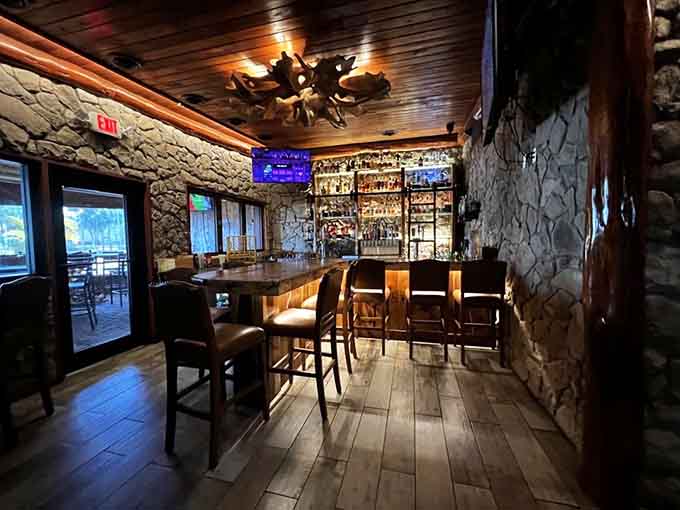The bar area features rich wood tones and enough bottles to make any cocktail enthusiast weak in the knees, in the best possible way.