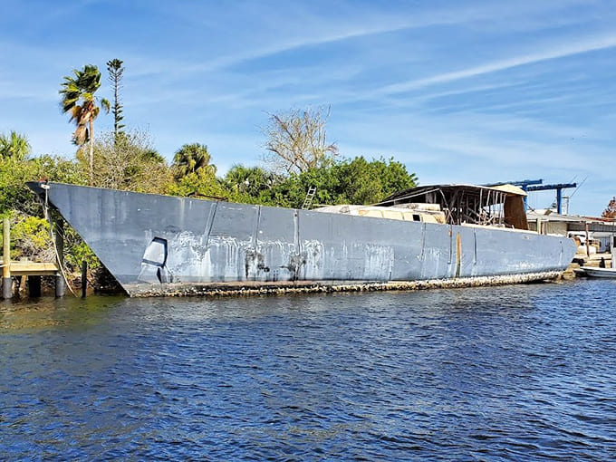 An abandoned vessel slowly returns to nature, its weathered hull a reminder of maritime history and the power of time and tide.