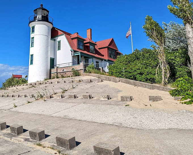Point Betsie Lighthouse stands proud against the blue sky, its red-roofed keeper's house a beacon of maritime history.