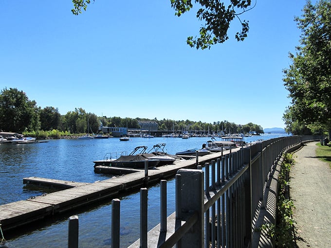 The lakeside path offers glimpses of docked vessels and distant shores, perfect for afternoon strolls and quiet conversations.