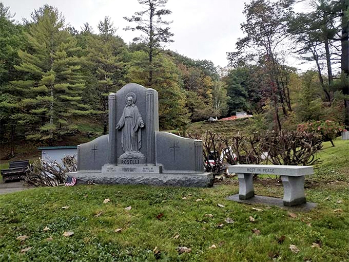 Serene devotion captured in marble, this peaceful memorial invites quiet reflection beneath Vermont's ever-changing skies.