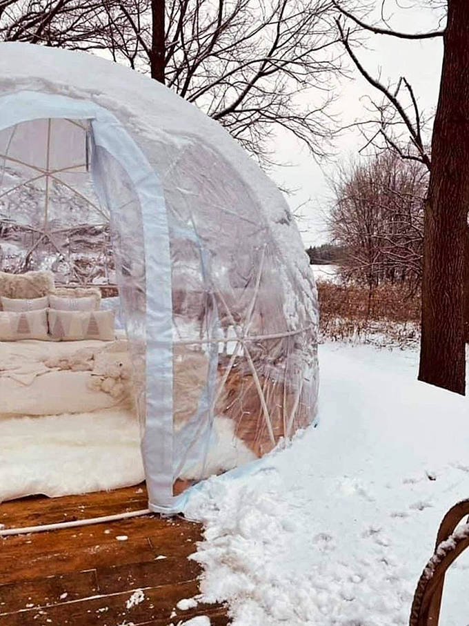 The dome's entrance frames a perfect vignette of winter white bedding against rustic wooden flooring &ndash; Instagram gold!