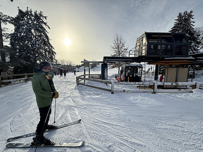 A lone skier surveys the morning slopes, enjoying that peaceful moment before the crowds arrive and the real party starts.