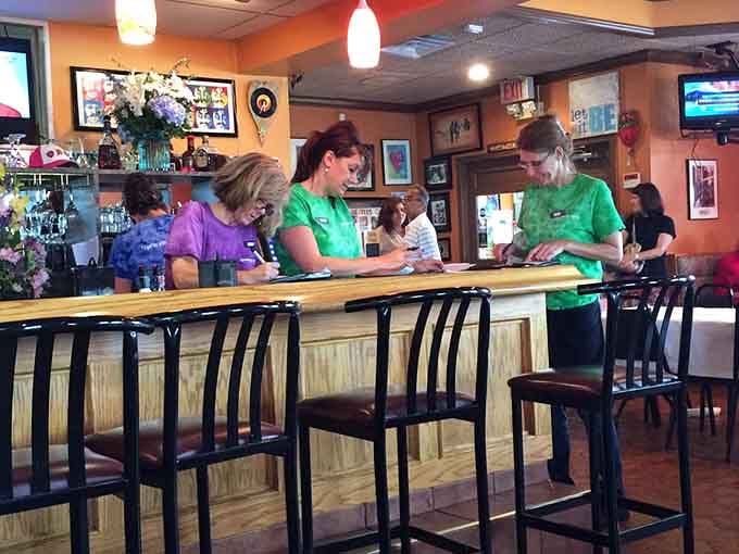 Friendly staff members in matching green shirts keep the restaurant running smoothly, treating every customer like a regular they're happy to see.
