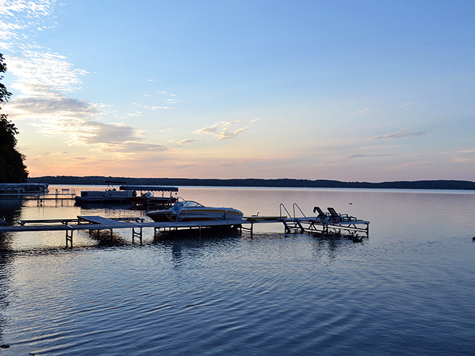 Golden hour magic transforms the lake into a painter's palette, with docks silhouetted against the day's final light show.