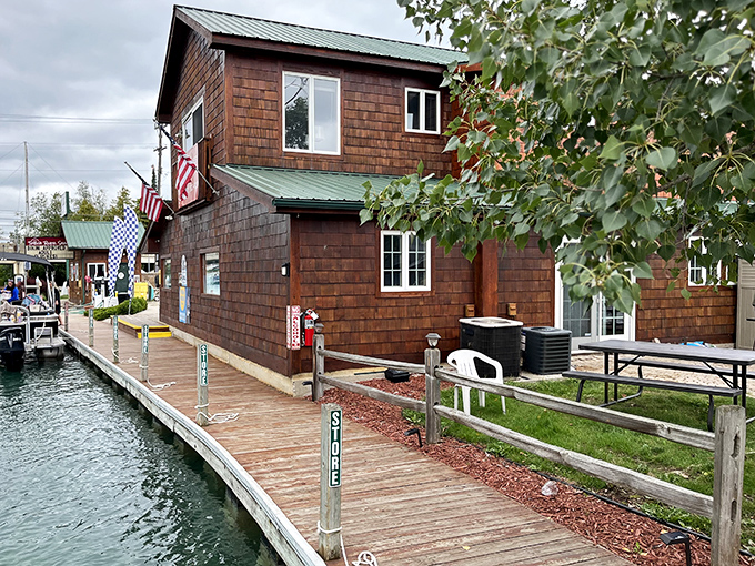 The Torch River Shack stands as a rustic gateway between worlds, connecting lake lovers to their aquatic playground.