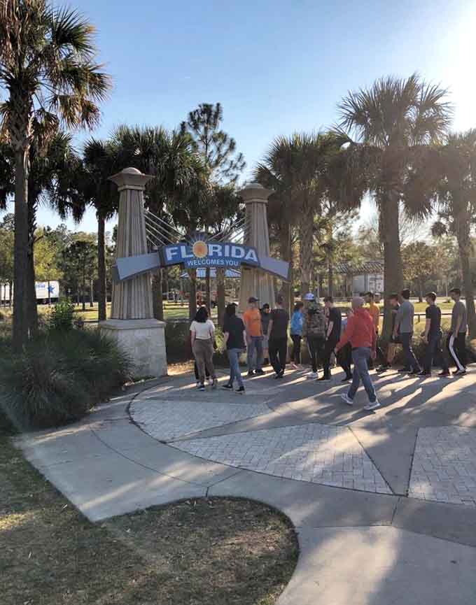 Groups gather for the obligatory welcome photo, because if you didn't document entering Florida, did you really cross the state line?