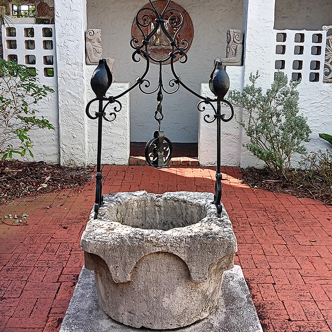 An ancient-looking Venetian wellhead stands sentinel, its weathered stone whispering tales of water rituals across centuries.