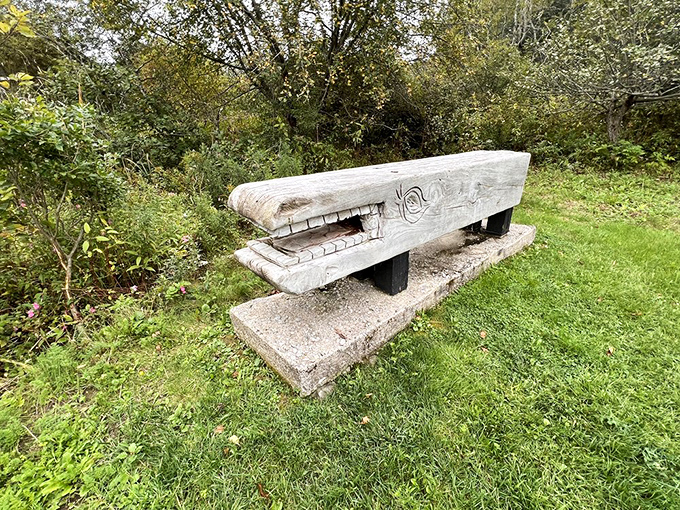 This wooden whale sculpture seems to swim through a sea of grass, its massive form both playful and imposing.