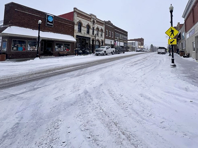 Winter transforms Harmony's main street into a snow-globe scene, where historic buildings shoulder their white blankets with the dignity of structures built to endure.
