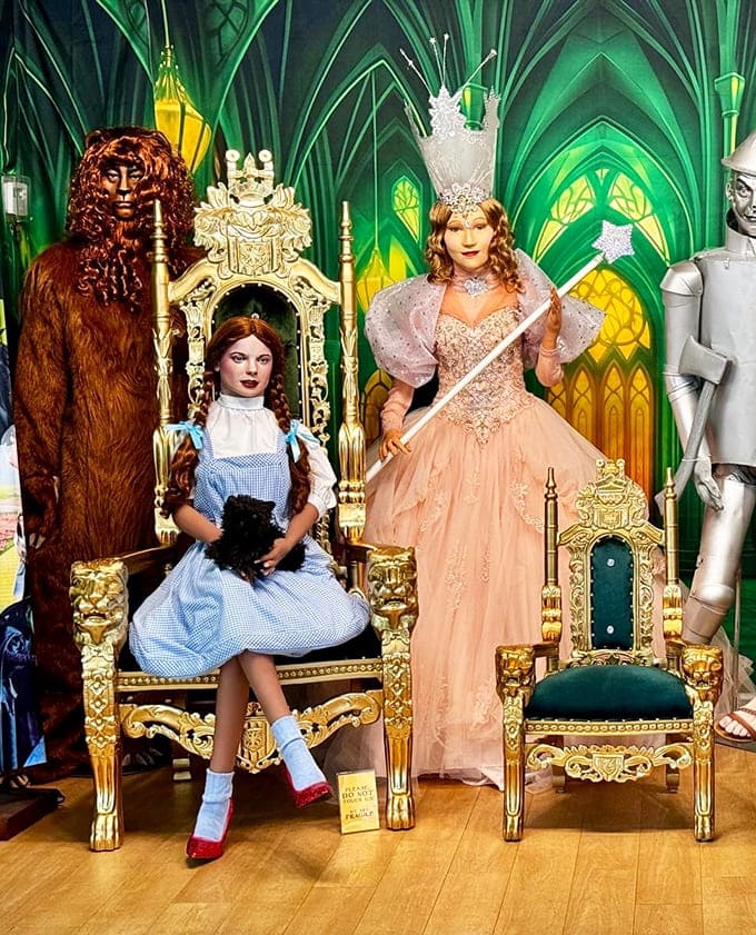 The whole gang gathers in the Emerald City throne room, ready for visitors to join them for photos fit for royalty.