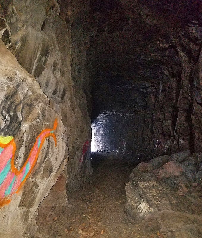 Tunnel vision: The mysterious passage through solid rock creates a perspective tunnel, drawing hikers into its historical depths.