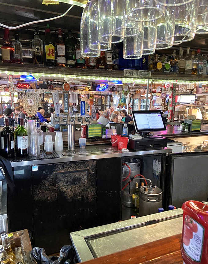 The bar at Cherry Pocket serves as social hub where fishermen swap tales while bartenders pour with practiced precision.