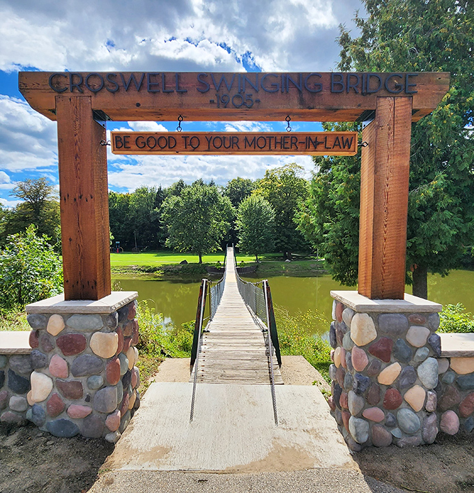 The rustic wooden entrance arch welcomes visitors with its timeless message, standing like a portal to simpler pleasures from a bygone era.