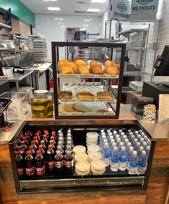 Fresh-baked bread displayed like the treasure it is, alongside bottled drinks waiting to complement your sandwich adventure.
