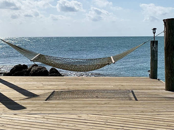 Hammock philosophy: Suspended between two posts with nothing but ocean views and the gentle rhythm of waves to disturb your thoughts.