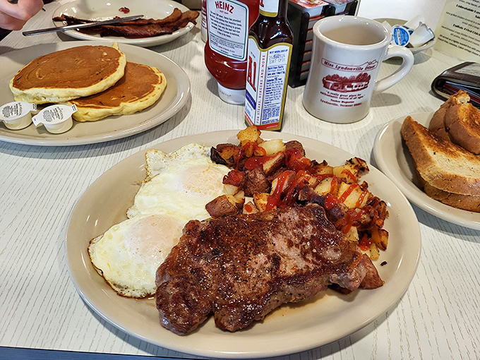 This hearty breakfast plate featuring steak, eggs, and home fries is the kind of meal that makes you feel like you could conquer mountains or nap gloriously.
