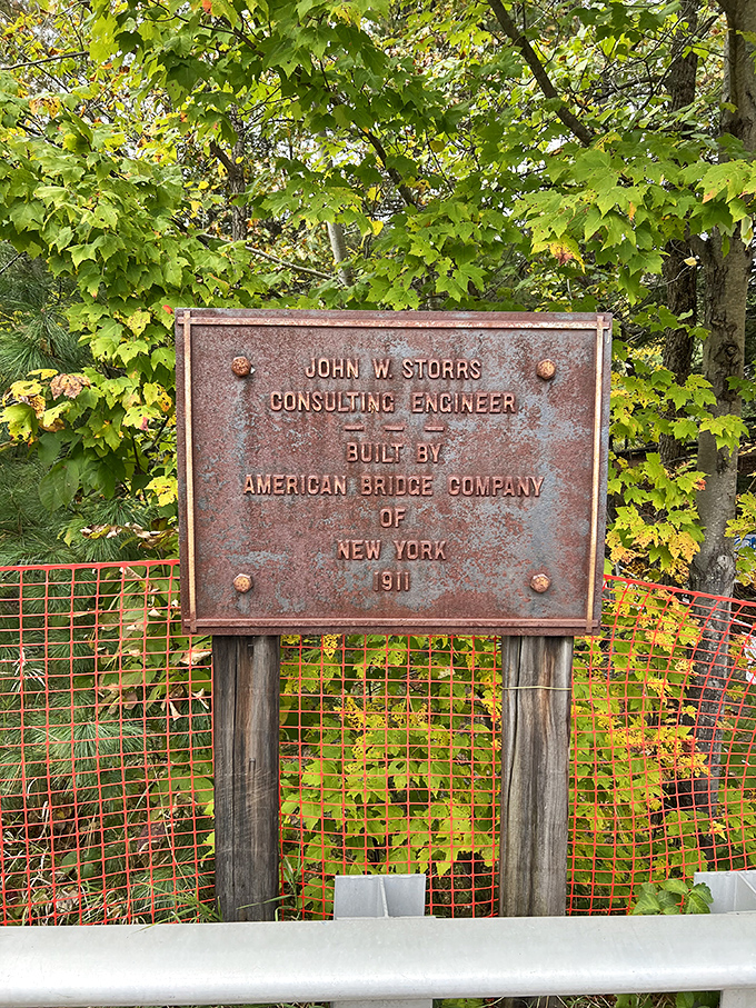 This weathered plaque reveals the bridge's 1911 origins, when the American Bridge Company of New York created what would become a Vermont icon.