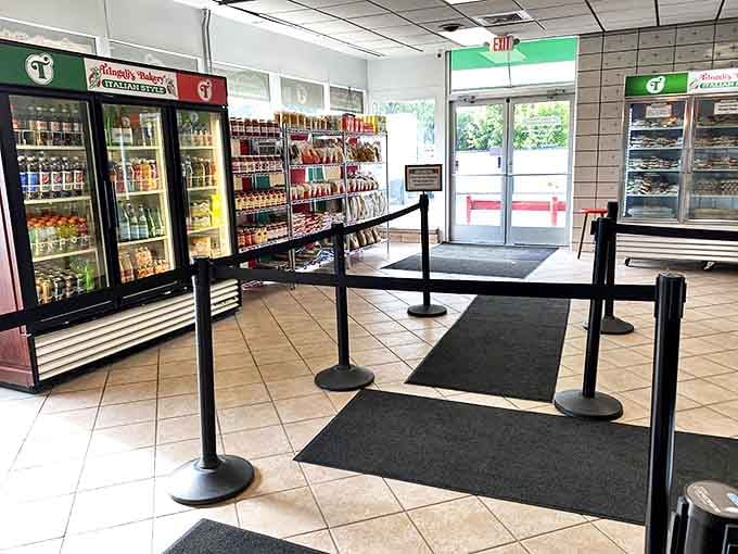 The entrance experience &ndash; where hope and hunger meet. That stanchion line has witnessed thousands of "I'll just get one thing" promises that never survive the display case.