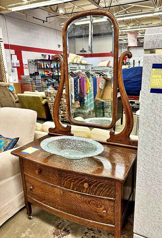 This antique vanity mirror has reflected countless faces over the decades and now waits to add vintage elegance to someone's bedroom or dressing area.