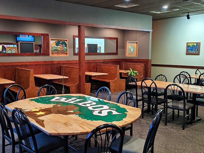 Wooden booths and tables create intimate dining spaces where friends gather to share stories and pizza with equal enthusiasm.
