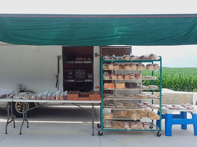 Under the simple green awning, fresh baked goods await weekend visitors – a roadside attraction worth every mile of the journey.