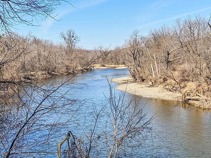 The Cannon River winds lazily through the valley, its gentle current reflecting bare winter trees along the shoreline.