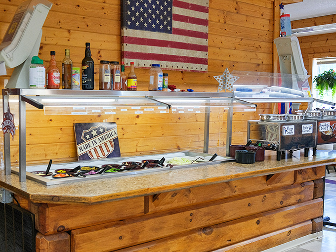 The salad bar station stands ready with fresh ingredients and homemade dressings under the watchful eye of Old Glory.
