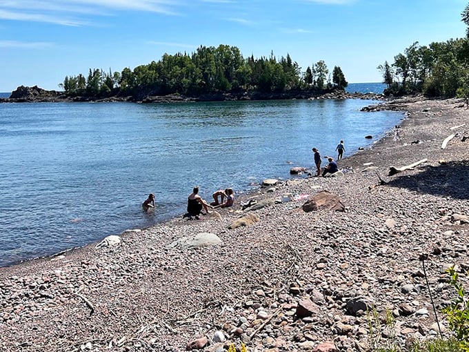 Visitors enjoy the simple pleasure of shoreline exploration, proving that sometimes the best entertainment doesn't require batteries or Wi-Fi.
