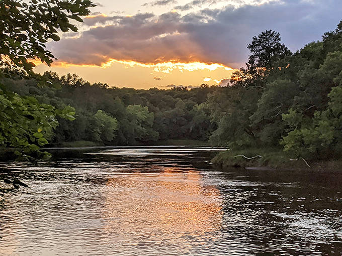 Sunset paints the river in molten gold, creating the kind of view that makes smartphone cameras feel wholly inadequate.