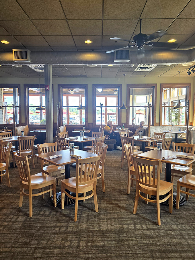 Empty tables waiting for stories to unfold, each one positioned to offer both privacy for conversation and communion with the lake views.