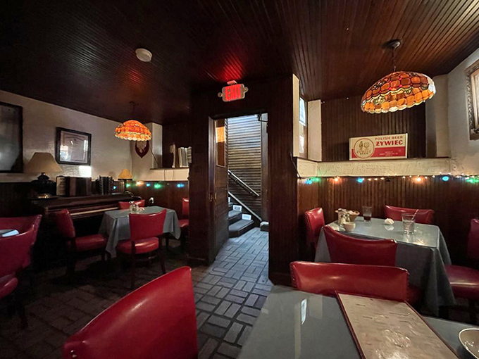 The dining room's warm wood paneling and red accents create a cozy atmosphere where time slows down and conversations deepen.