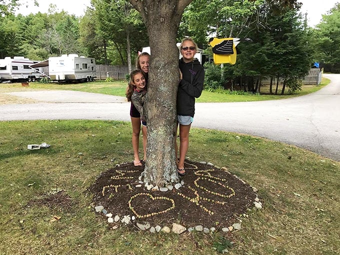 Campers gather around trees decorated with natural art &ndash; proof that the best vacation activities sometimes happen spontaneously.