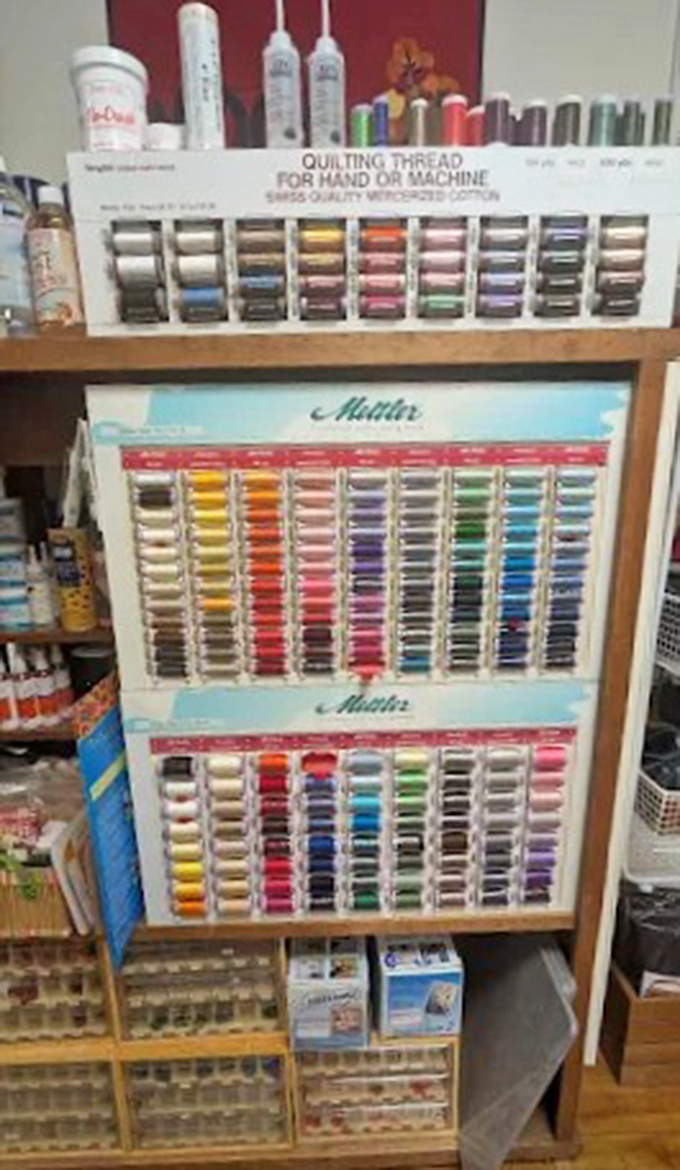 The heart of operations &ndash; this well-worn counter has witnessed thousands of creative dreams being cut, measured, and sent home to become heirlooms.