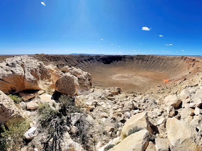 The massive Meteor Crater carves a perfect bowl into the Arizona landscape, a 50,000-year-old reminder of our planet's cosmic connections.