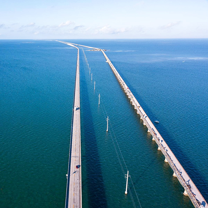 Aerial view of the Seven Mile Bridge showcases the stunning blues of the Florida Keys waters. From above, it's easy to see why this drive is considered one of America's most scenic.