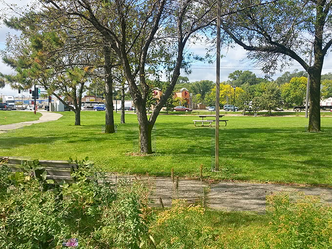 Green space meets community gathering spot in this riverside park, where benches invite contemplation and picnic tables welcome family gatherings.