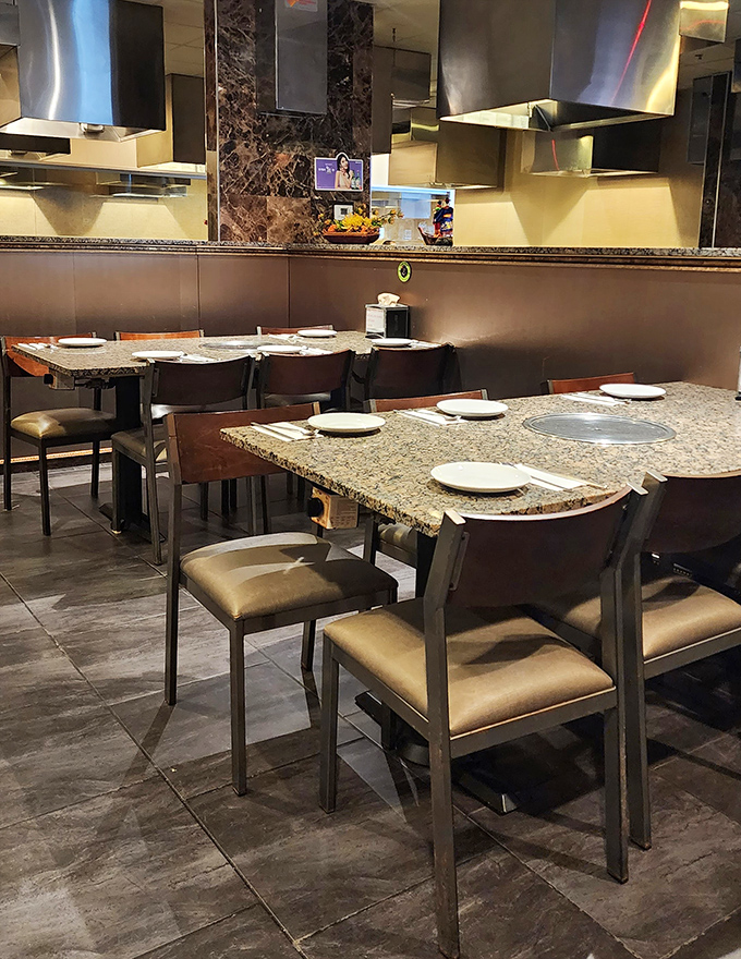 Granite tables and comfortable seating create intimate dining spaces where conversations flow as freely as the delicious food from kitchen to table.