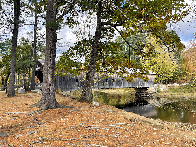 Fall leaves carpet the approach to the bridge, nature's red carpet rolled out for this star of Maine's architectural heritage.