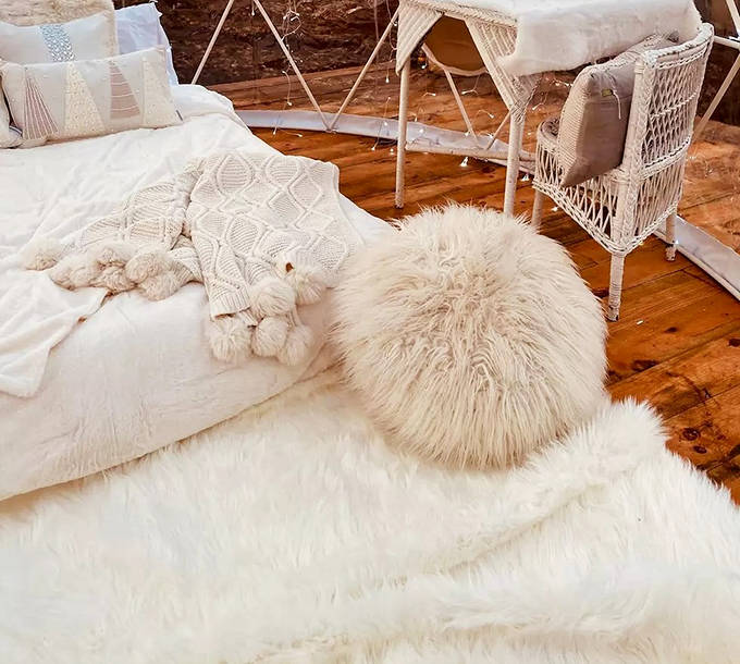 Every textile inside the dome seems chosen to echo winter's softness, creating a cocoon of comfort amid geometric precision.