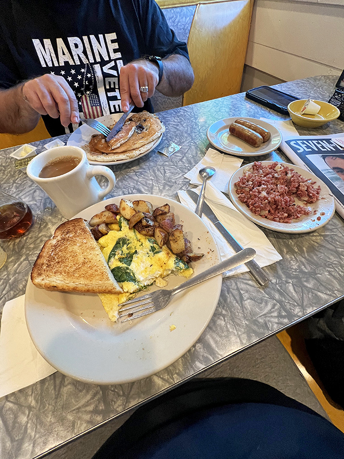 The holy trinity of diner perfection&mdash;golden toast, farm-fresh eggs, and home fries sharing plate space with what appears to be corned beef hash heaven.