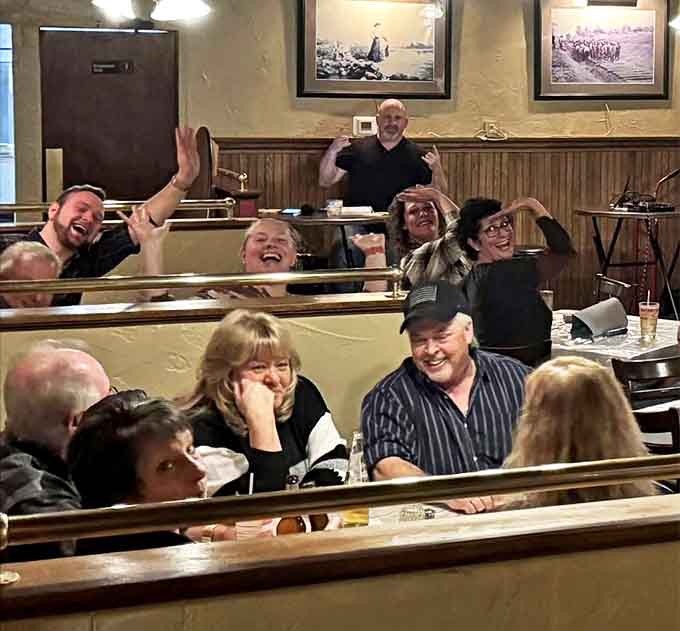 Happy diners enjoying their meal, blissfully unaware or completely comfortable with their supernatural dining companions.