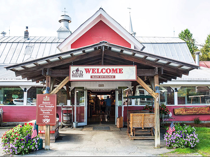 Cold Hollow Cider Mill welcomes visitors with a splash of red against Vermont green, promising apple-based delights that will ruin ordinary cider forever.
